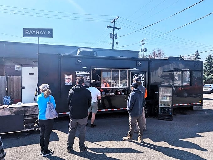 The black food truck of destiny stands ready, its "RAY RAY'S HOG PIT" sign a beacon to barbecue pilgrims seeking smoky salvation in Columbus.