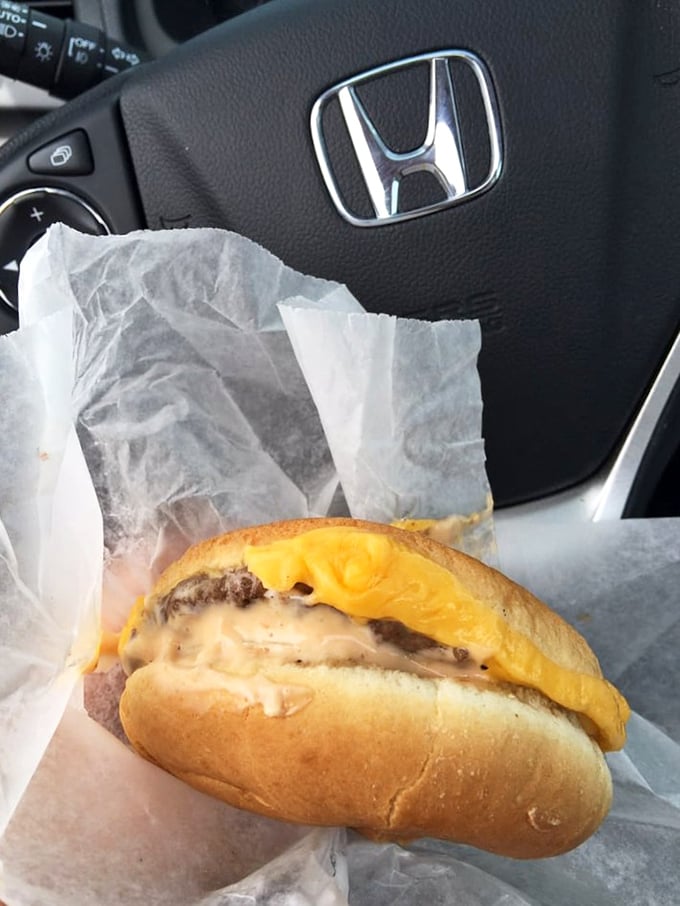 The California burger in its natural habitat—your car. Melty cheese, special sauce, and fresh toppings create a handheld masterpiece worth the inevitable dashboard crumbs.