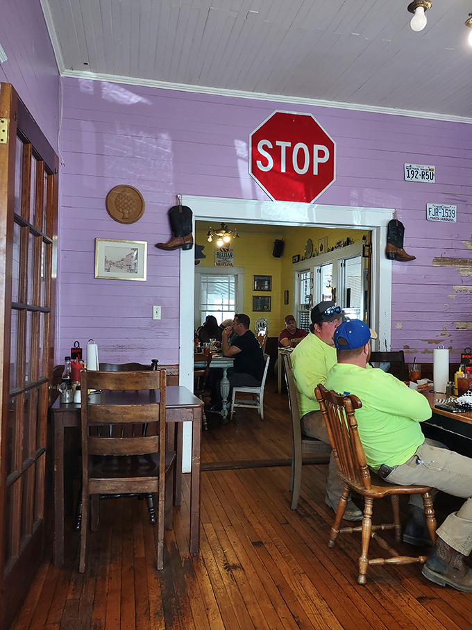 Under the watchful eye of a vintage stop sign, diners engage in the sacred ritual of serious eating—conversation optional.