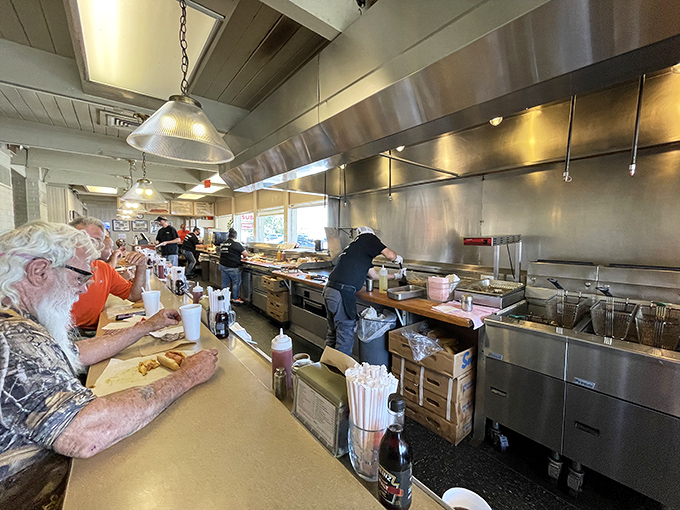 The gleaming stainless steel kitchen is like watching a well-choreographed dance—if the dancers were making delicious hot dogs instead of pirouettes.