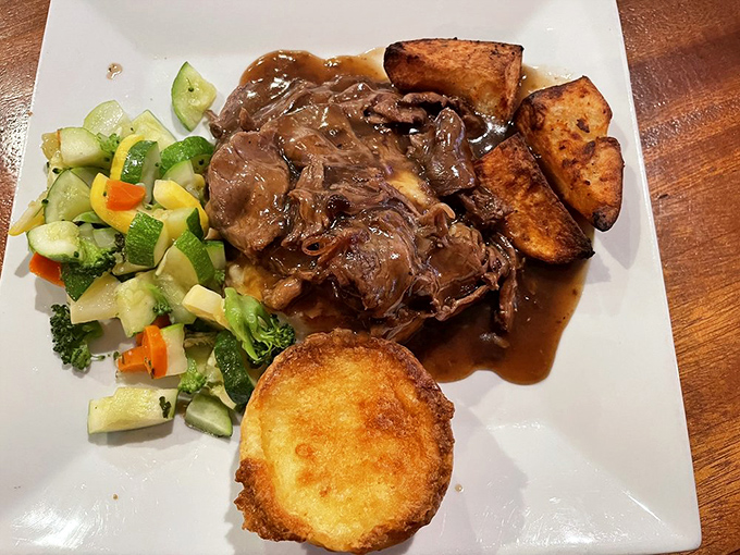 Sunday roast perfection—tender beef bathing in rich gravy alongside golden potatoes and fresh vegetables. Your grandmother would approve.