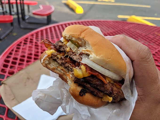 This burger doesn't need Instagram filters—its melty cheese and bacon are performing visual poetry all on their own.