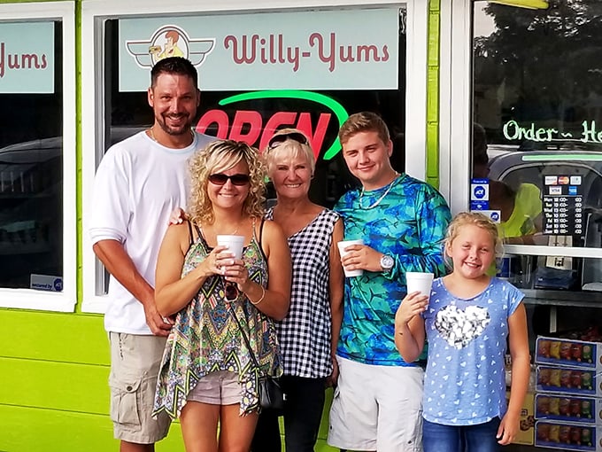Happy customers outside Willy-Yums with drinks in hand. That smile says what words can't—"I've found my happy place, and it serves hot dogs."