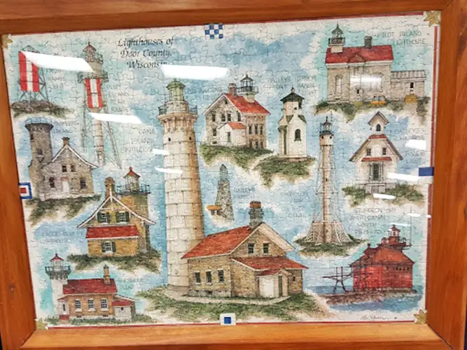 Wisconsin's lighthouses immortalized in puzzle form! Someone spent hours assembling this—now it can grace your wall for a fraction of gallery prices.
