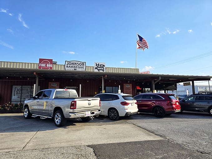 That American flag flying high signals patriotic dedication to one of America's greatest traditions – proper roadside barbecue.