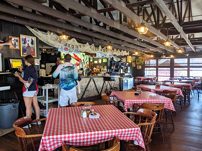 The heart of The Crab Claw's operation—where drinks are poured, orders are called, and the rhythm of a well-loved restaurant plays out all day long.