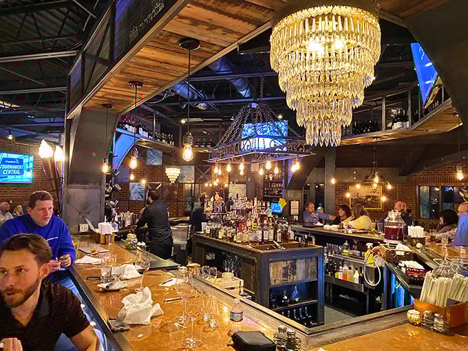 The bar gleams under crystal chandeliers like a bourbon-lover's fantasy come to life. Industrial chic meets Kentucky hospitality in perfect harmony.