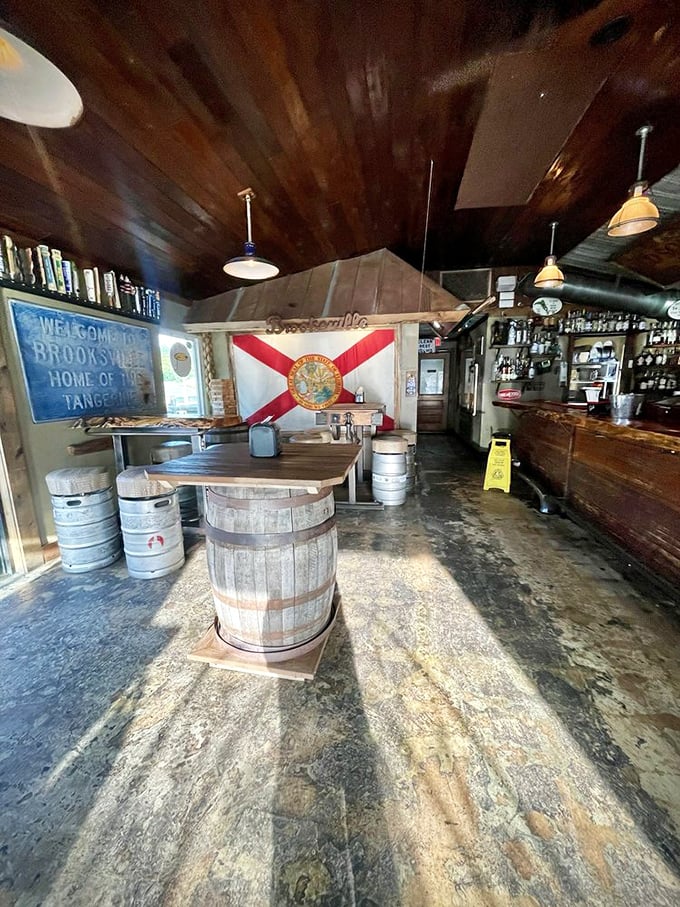 Florida state pride on full display with that flag backdrop. The barrel tables aren't just decoration—they're conversation starters with a side of history.