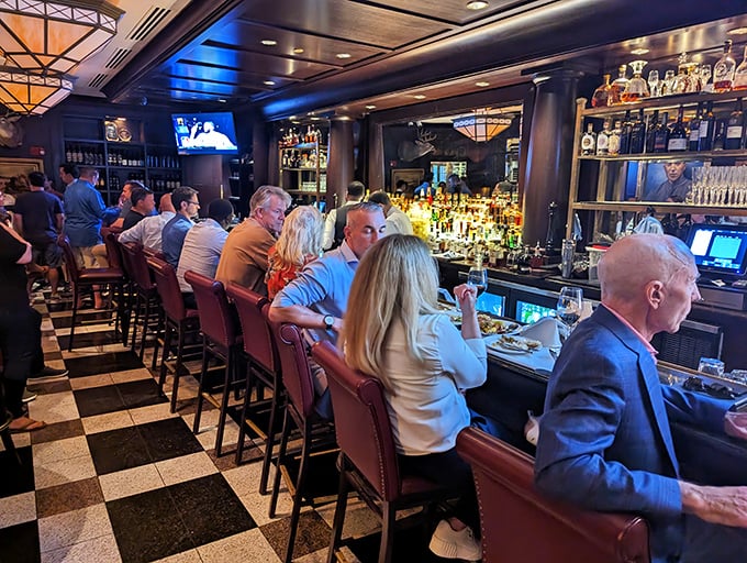 The checkered floor leads to a promised land of bottles and friendly faces. Here, strangers become friends over properly crafted Manhattans.