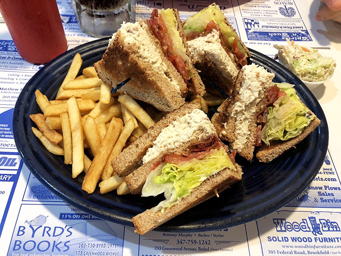 The club sandwich—cut into four perfect triangles because some traditions, like geometric sandwich satisfaction, should never change.