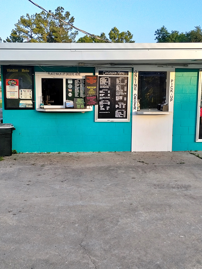 The concession stand's turquoise charm beckons with promises of buttery popcorn and ice-cold sodas—intermission's main attraction.