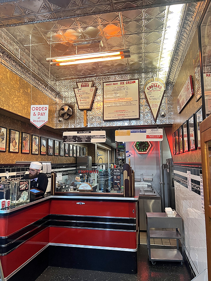 Art deco meets dairy perfection beneath a gleaming tin ceiling. This isn't just an ice cream counter—it's dessert's hallowed ground.