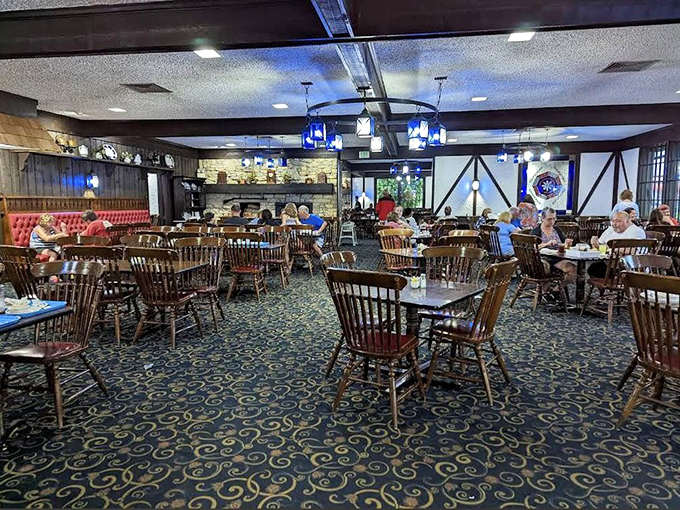 Wooden chairs, blue carpet, and stone fireplace create the perfect backdrop for food that tastes like childhood—even if you grew up eating TV dinners.