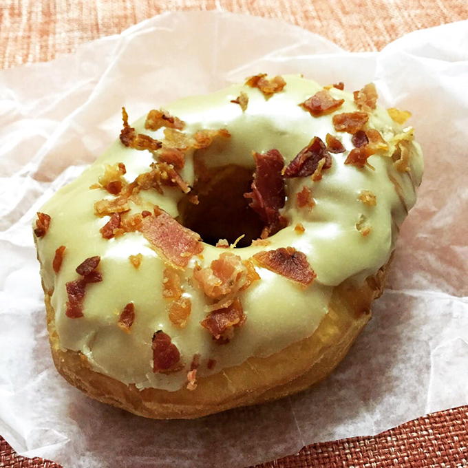 Pale green glaze sprinkled with bacon bits—a savory-sweet combination that makes your taste buds feel like they've won the lottery.