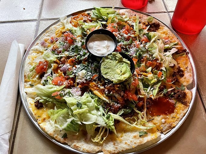 A taco pizza that couldn't decide what it wanted to be when it grew up. The guacamole center acts as both dip and emergency cooling system.
