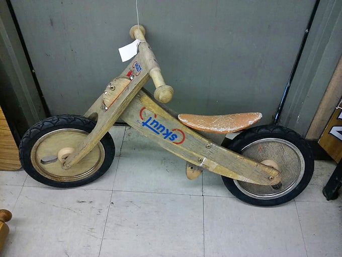 A wooden balance bike that's already broken in the hard part—learning to ride. Some lucky child's first wheels await their next adventure.
