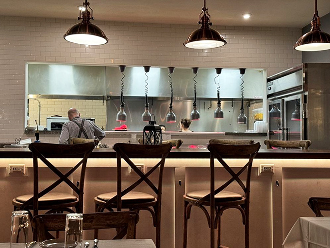 The open kitchen concept isn't just trendy—it's dinner and a show. Those pendant lights cast the perfect spotlight on culinary craftsmanship in action.