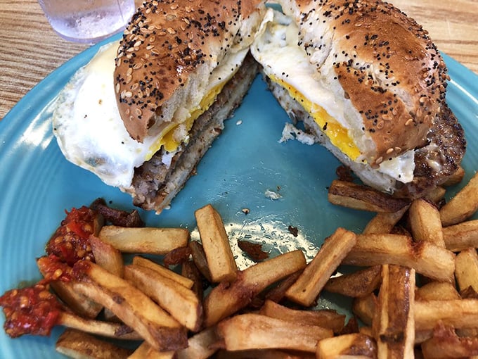 The breakfast sandwich that launched a thousand road trips—a perfectly toasted everything bagel embracing eggs and meat in a handheld symphony.