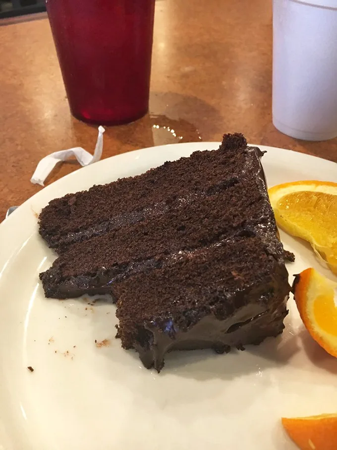 Chocolate cake so rich it should come with its own tax bracket. Those layers aren't just dessert—they're therapy without the hourly rate.