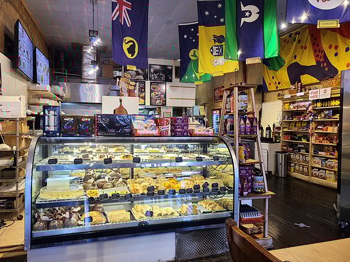 The display case—a treasure chest of savory pies and sweet treats that would make any Australian expat weep with joy.