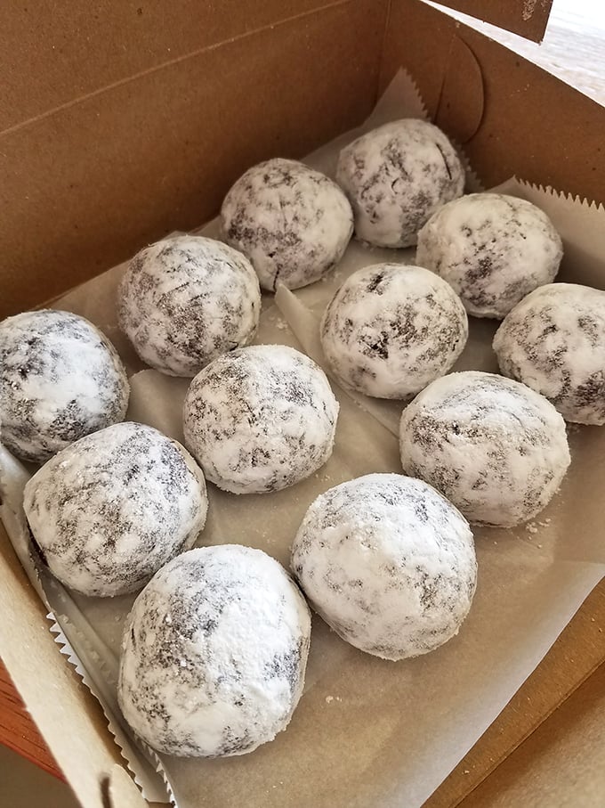 Powdered donut holes – the perfect bite-sized morsels of joy that somehow always leave evidence on your shirt.
