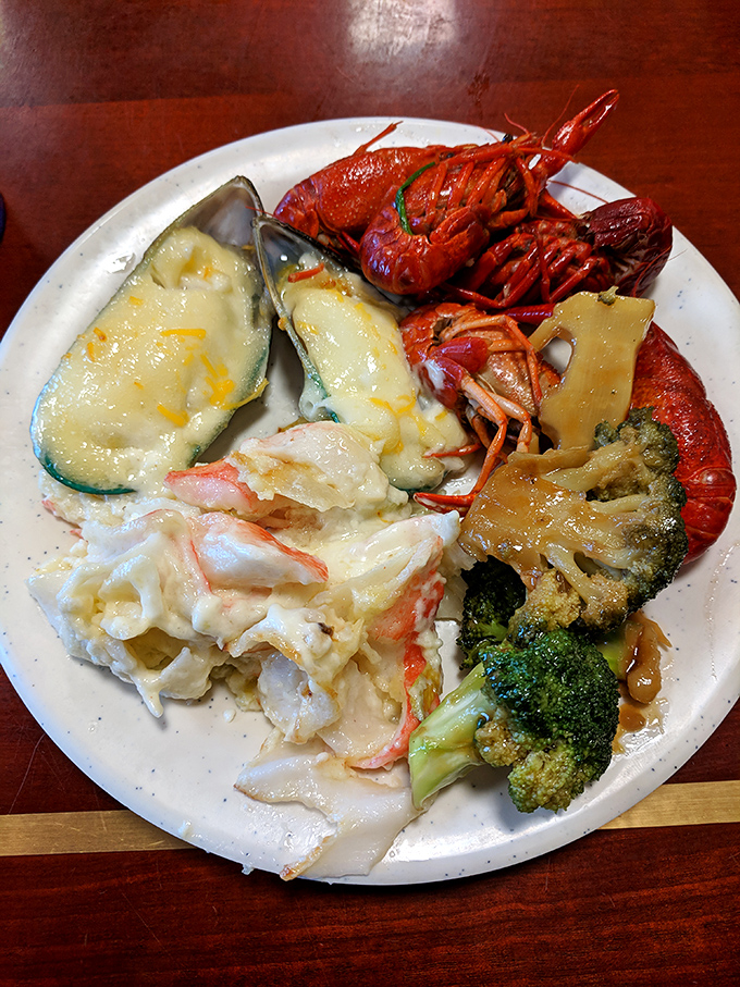 Crystal chandeliers watch over islands of culinary treasures. This isn't just a buffet – it's a food palace worthy of its royal name. 