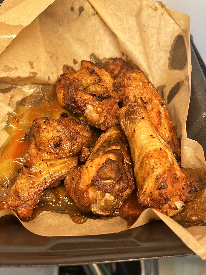 These wings aren't just cooked—they're transformed. Swimming in their own glorious juices, they're the reason napkins were invented.