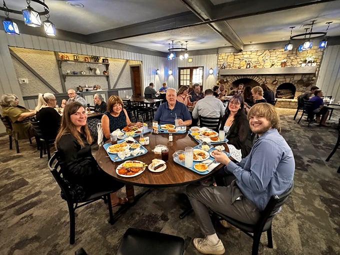 Happy diners gathered around a feast that spans generations. When the food arrives, conversation pauses—the highest compliment in the Midwest.