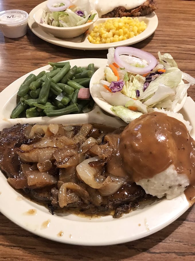 Liver and onions with mashed potatoes swimming in gravy—a dish that separates the true comfort food connoisseurs from the pretenders