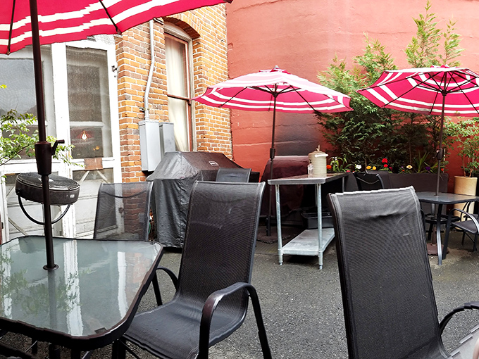 Outdoor seating with bright red umbrellas offers a splash of color against brick walls—the perfect spot for breakfast with a side of people-watching. 