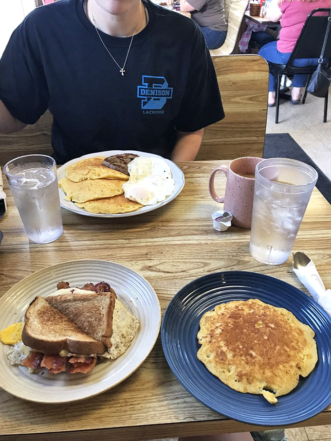 A table that tells the story of breakfast democracy—everyone gets exactly what they want, from classic egg sandwiches to pancakes with the perfect golden hue.