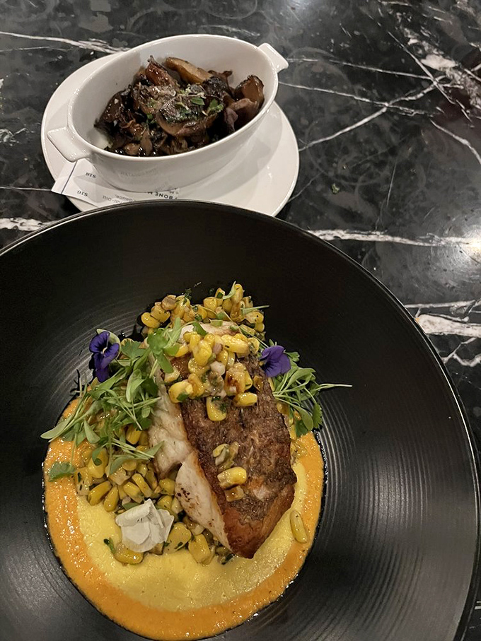 Fish that doesn't need to be "dressed up" to impress, resting on a vibrant corn purée that's summer sunshine translated into food.