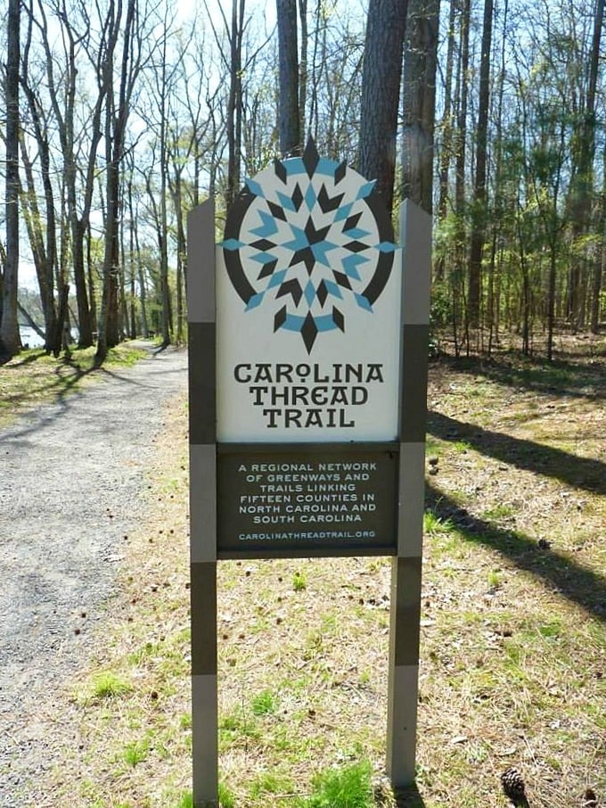 The Carolina Thread Trail sign marks one thread in a tapestry of pathways connecting fifteen counties—wanderlust made legitimate.