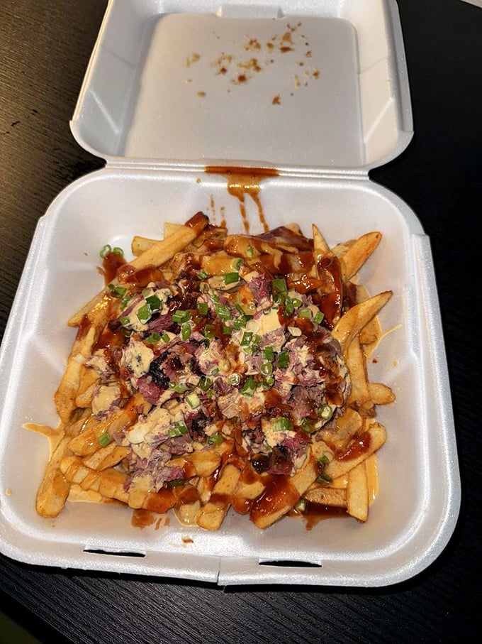 Dirty fries that would make a cardiologist wince and a food lover weep—crispy potatoes topped with meat, sauce, and green onions for good measure.