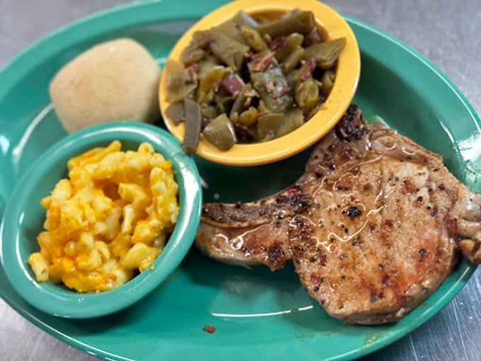 This pork chop isn't just cooked – it's been loved, alongside mac and cheese and green beans that complete comfort food's holy trinity.
