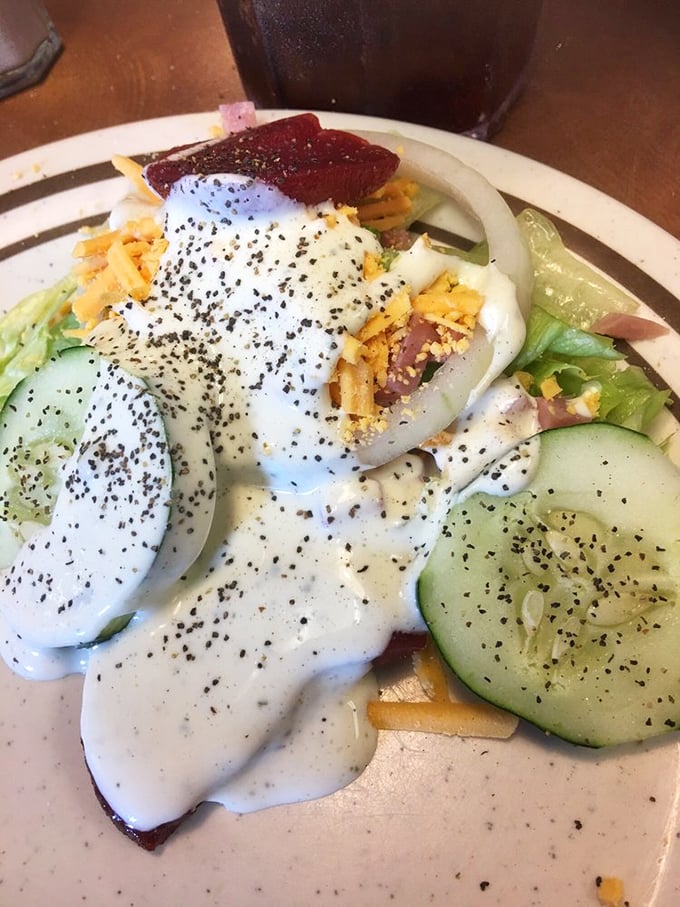 A garden-fresh salad drizzled with ranch and topped with shredded cheese – because at a Southern buffet, even the vegetables get dressed up.