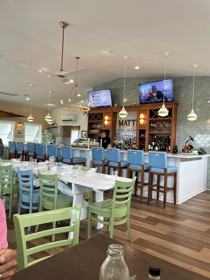 Where coastal casual meets culinary serious – blue bar stools, green chairs, and staff who know their oysters better than most know their neighbors.