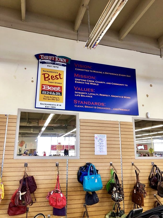 The handbag wall—where designer dreams meet thrift store prices. That blue tote might have once carried important documents to important meetings.