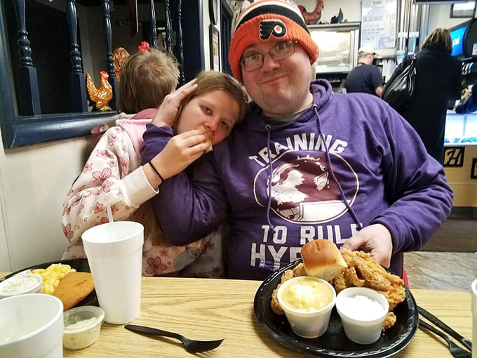 The universal expression of fried chicken bliss—where family memories are made one crispy bite at a time.