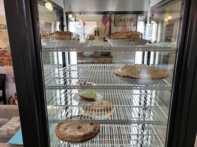 The pie display case—where life-changing decisions are made daily and "I'll just have a small slice" becomes the lie we tell ourselves.