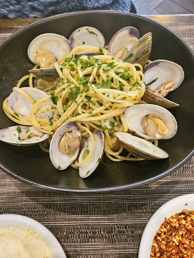 Linguine with clams—where pasta meets the sea in a beautiful friendship. Those open shells are nature's way of applauding the chef.