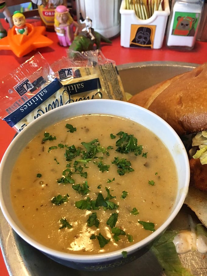 This isn't just soup—it's a creamy planetary pool of shrimp and tarragon bisque, garnished with fresh herbs and served with crusty bread for dipping.