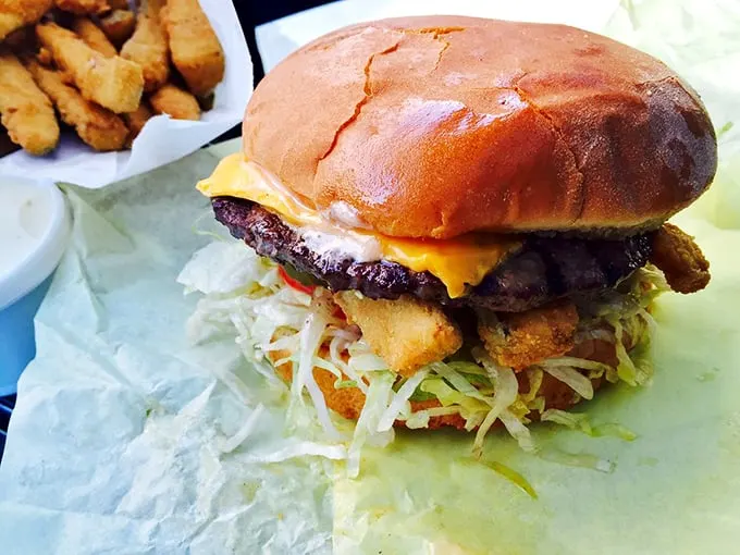 This isn't just a burger—it's architecture, engineering, and art all stacked between two buns. The onion rings? That's just showing off.