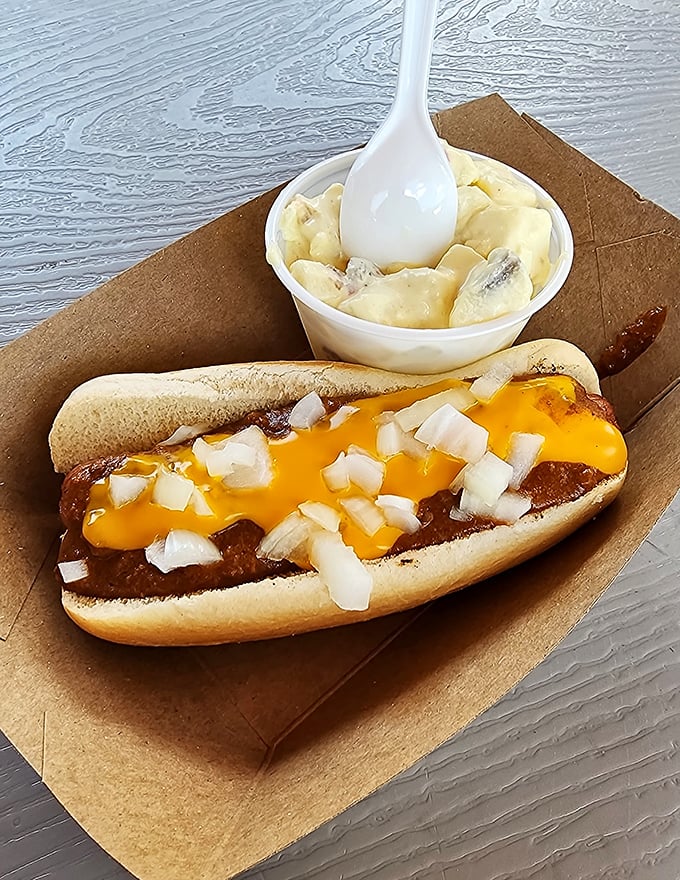 The Detroit-style coney in its natural habitat—smothered in chili, draped with melted cheese, and sprinkled with diced onions. A beautiful mess worth every napkin.