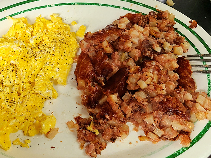 Scrambled eggs and corned beef hash—a breakfast power couple that belongs in the Comfort Food Hall of Fame. Simple perfection on a plate with that signature green-rimmed diner china.