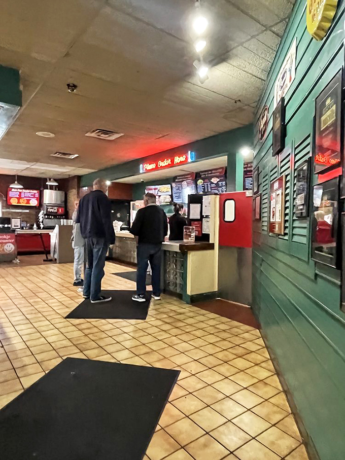 The glass block counter and digital menu boards blend old-school charm with modern efficiency—just like the perfect burger joint should.