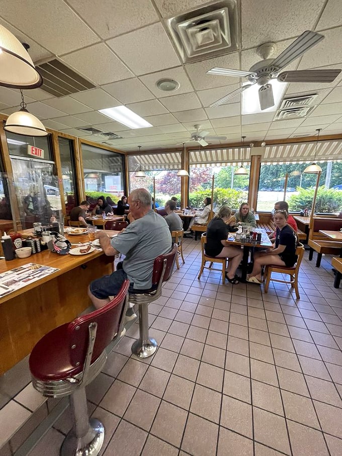The true measure of a breakfast spot isn't just the food, but the community it creates – strangers becoming neighbors over shared maple syrup bottles.
