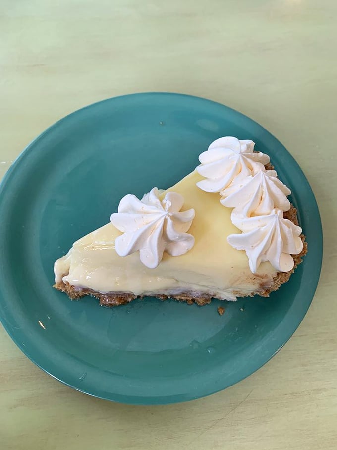 This slice of Key lime pie isn't playing hard to get—it's showing off its pale yellow authenticity and creamy confidence on a turquoise stage.