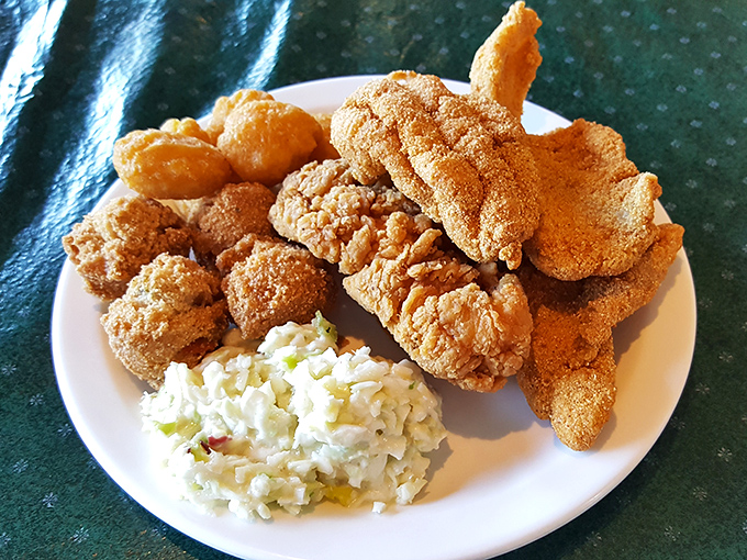 This isn't just fried fish—it's edible gold, with a cornmeal crust that shatters with each bite revealing flaky perfection beneath.