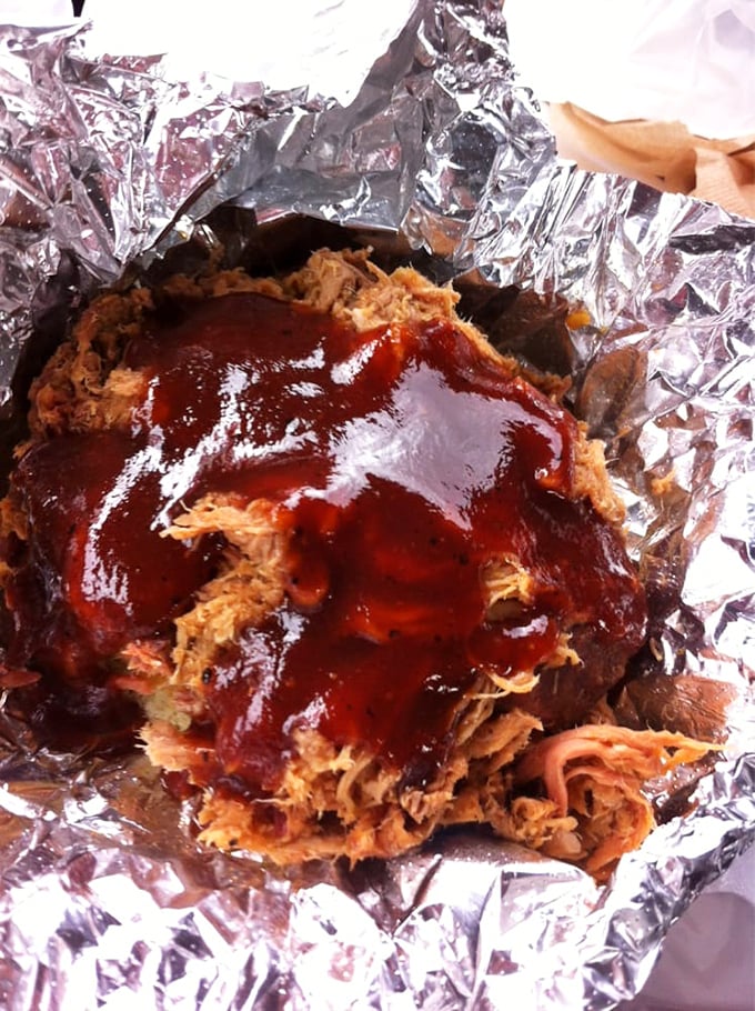 Pulled pork so tender it practically surrenders to the fork, glistening with that signature sauce that walks the perfect sweet-tangy tightrope.